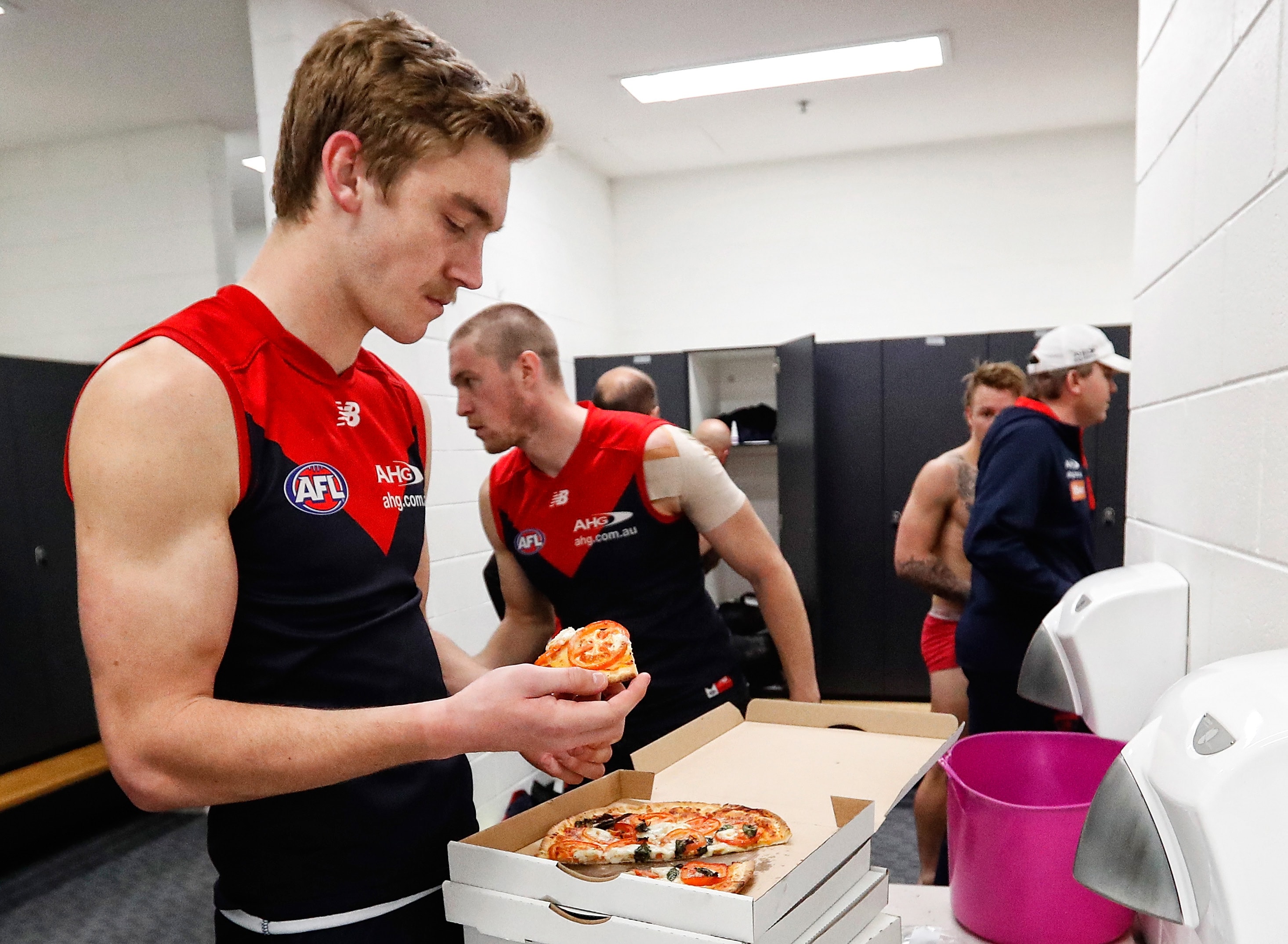 Strawberry milk and pizza: Inside an AFL changeroom post-game
