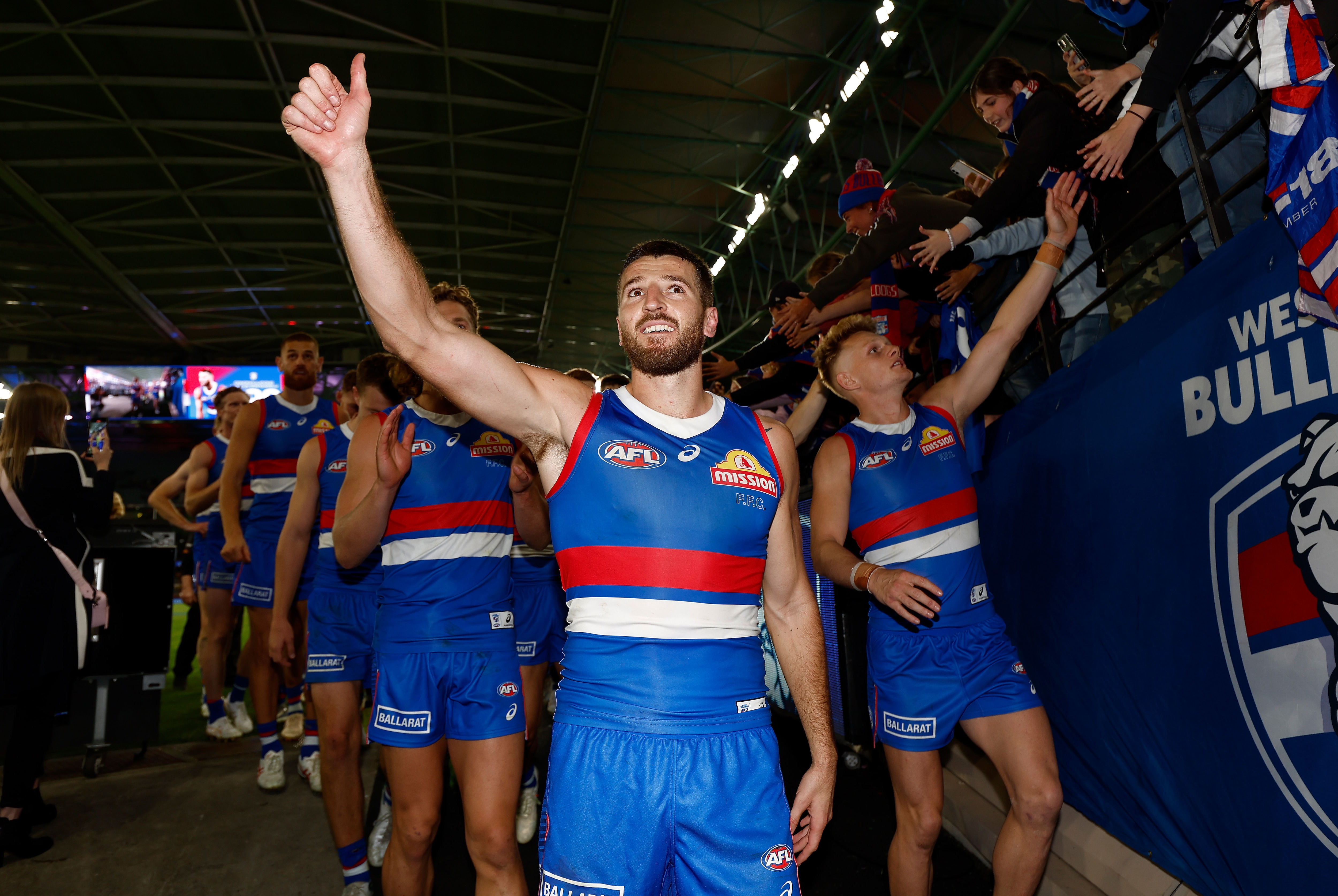 Dogs celebrate Bont's milestone with gritty win over gallant Hawks