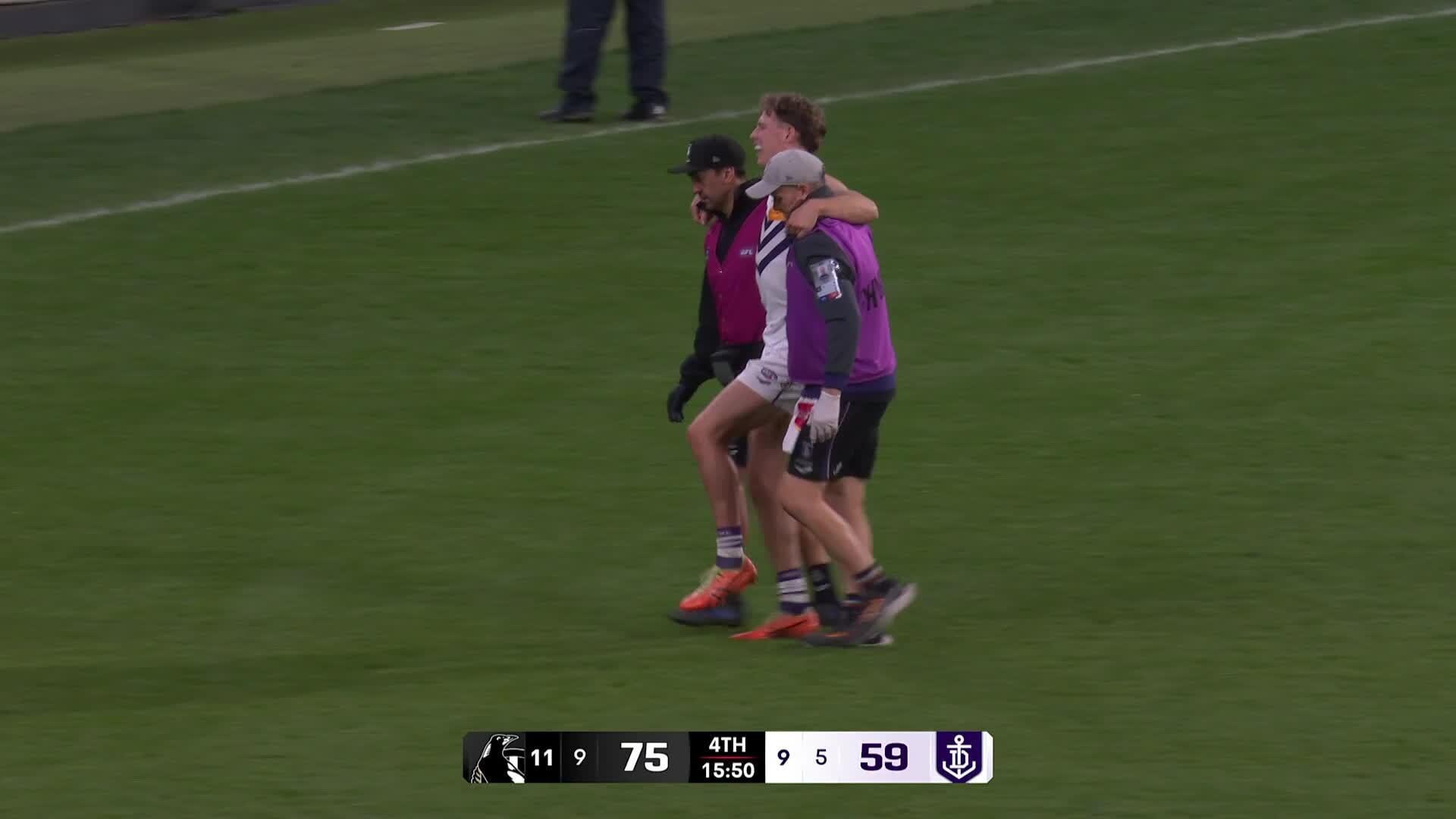 Docker leaves ground in arms of trainers after brutal incident