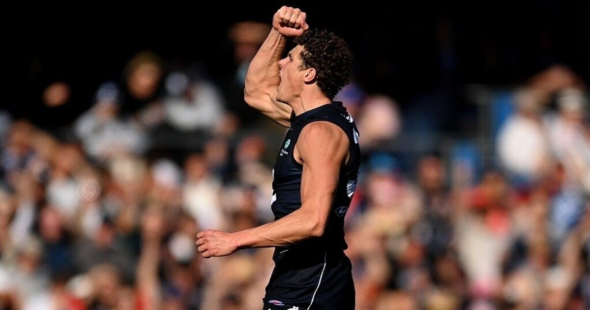 Charlie flexes his muscles to lift the Blues
